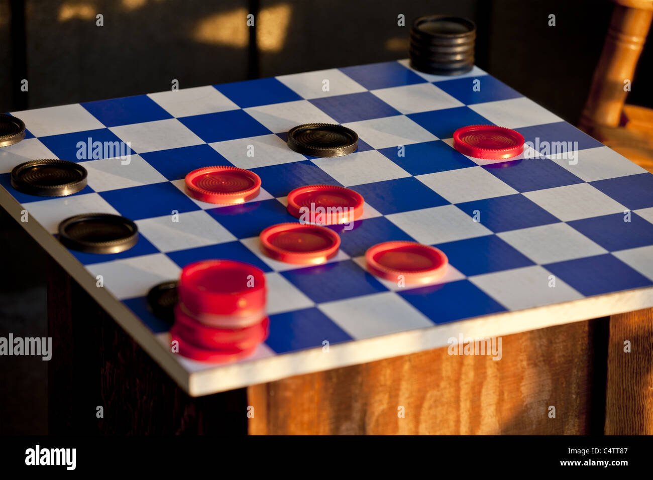 CHECKER GAME BOARD WITH STRONG SIDE LIGHTING Stock Photo - Alamy