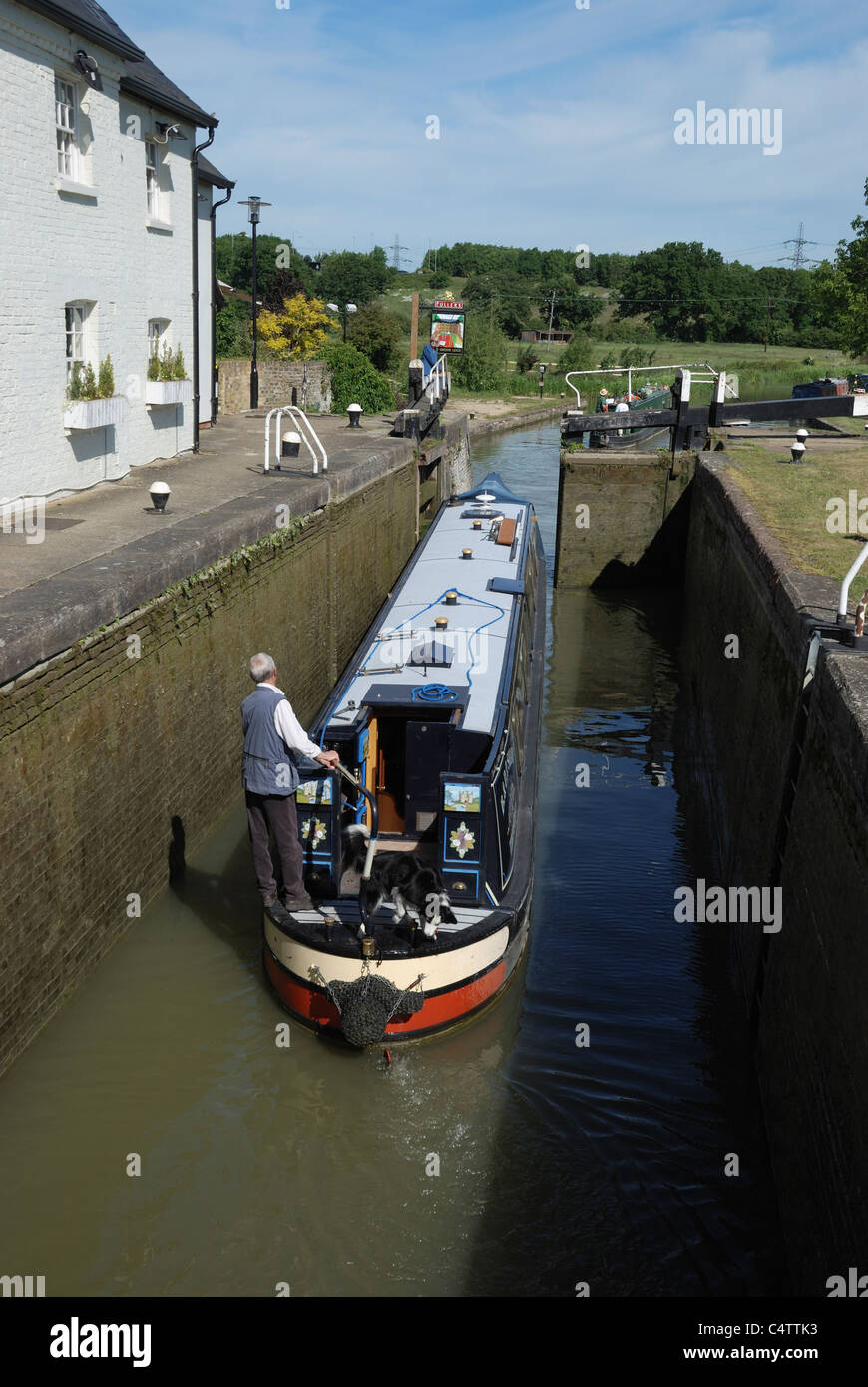 A traditional english narrowboat exiting Grove Lock on the Grand Union ...