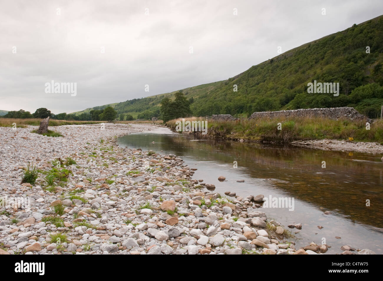 River Skirfare in steep-sided valley (low shallow water, drought, dry ...
