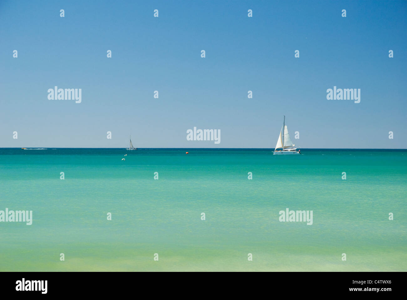 A sailing boat on the horizon Stock Photo - Alamy