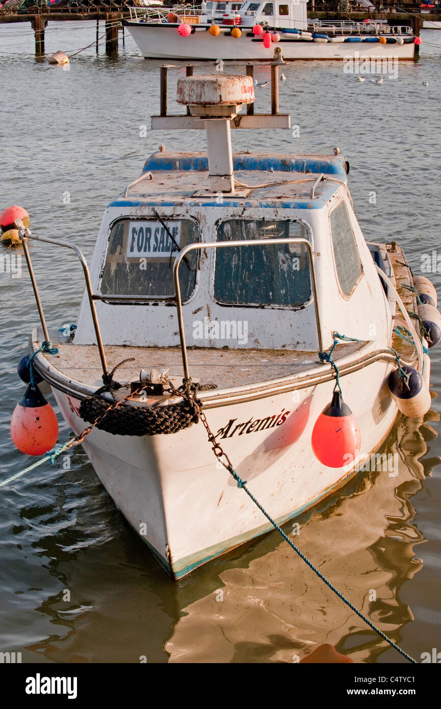 Bridlington harbour in evening sun (small dirty fishing boat moored ...