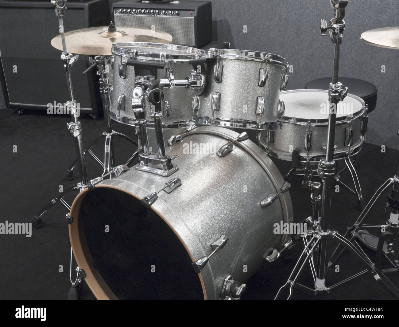 Silver drum kit with amplifiers in the background Stock Photo - Alamy