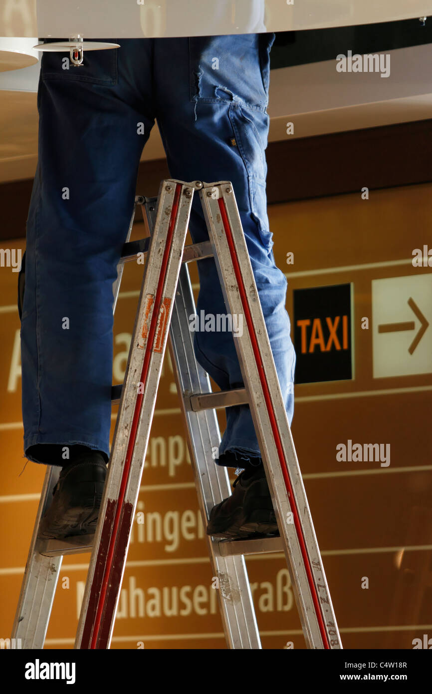 Man standing on a ladder, Munich Upper Bavaria Germany Stock Photo - Alamy