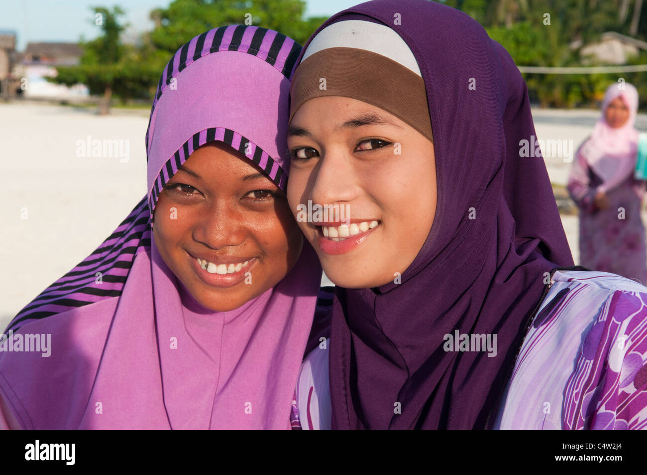 Muslim girls with big smiles on Mabul Island in Borneo, Malaysia Stock ...