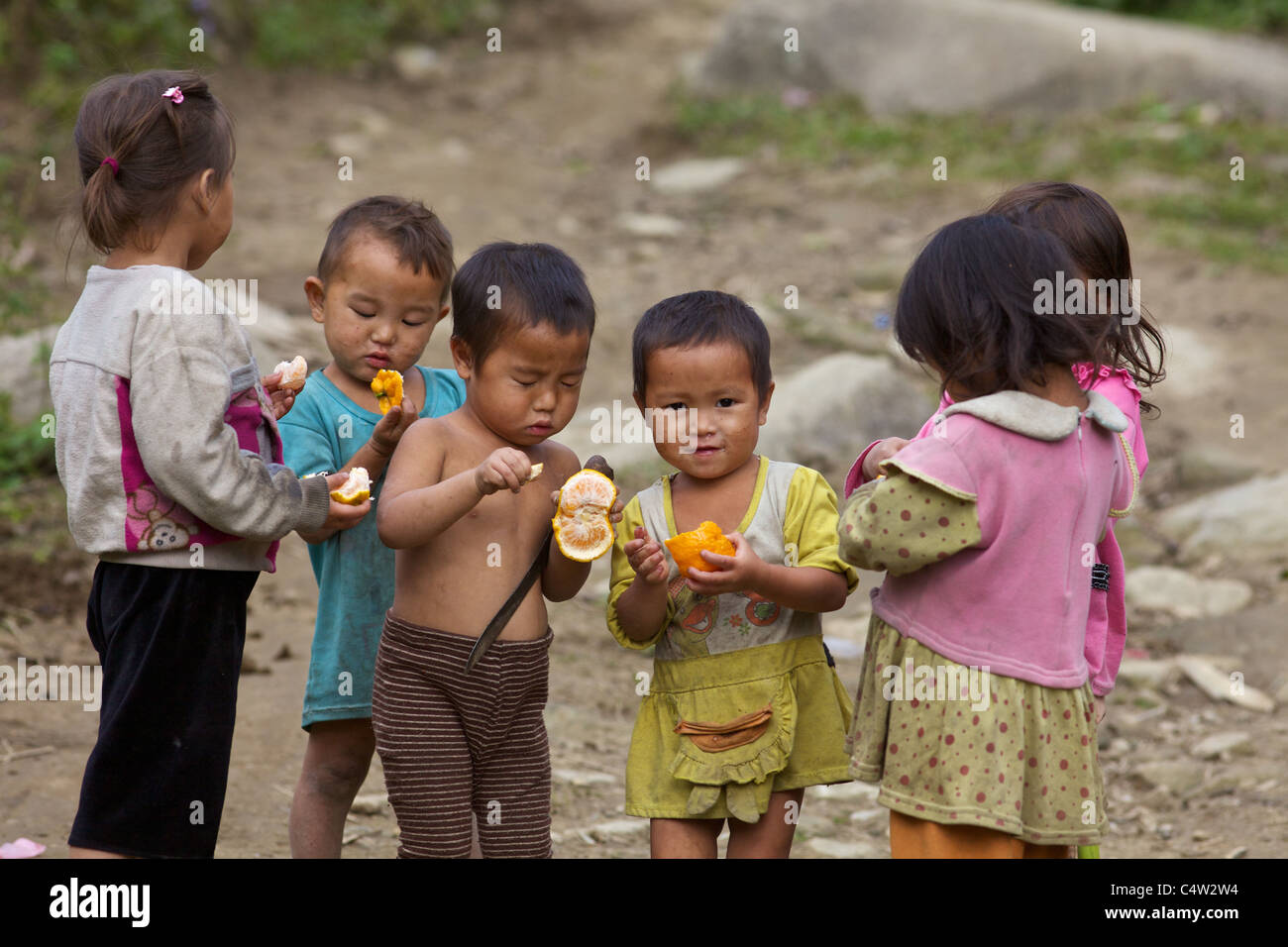 Six unidentified Vietnamese children play and eat in Sapa, Vietnam ...