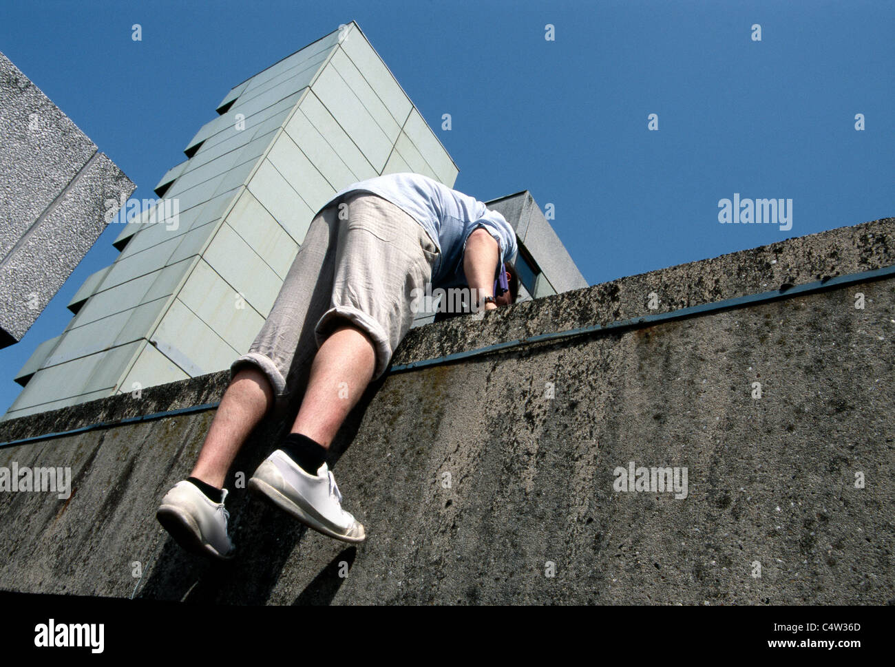 Person going over wall Stock Photo - Alamy