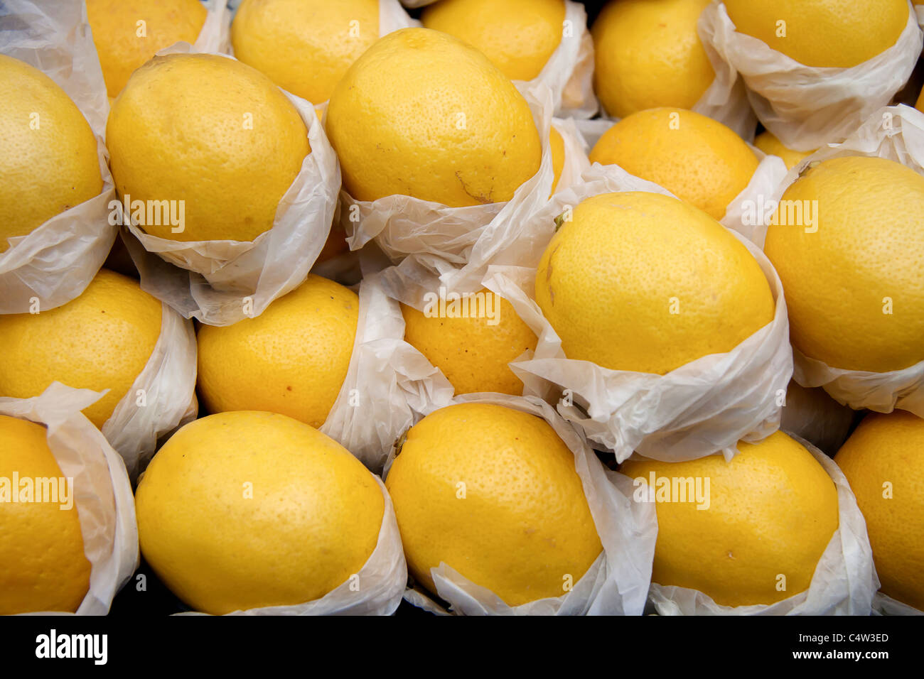 Paper wrapped lemons on shop counter Stock Photo - Alamy