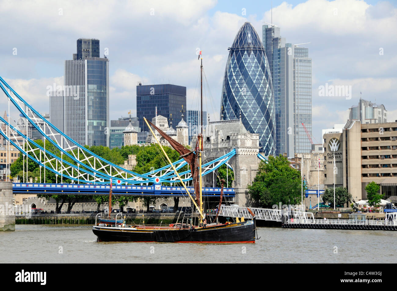 Thames barge with City of London skyscraper skyline beyond Tower Bridge ...