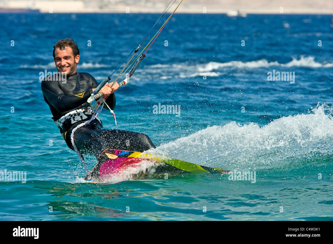 A close up view of a kite surfer skimmimg across the sea at the resort ...