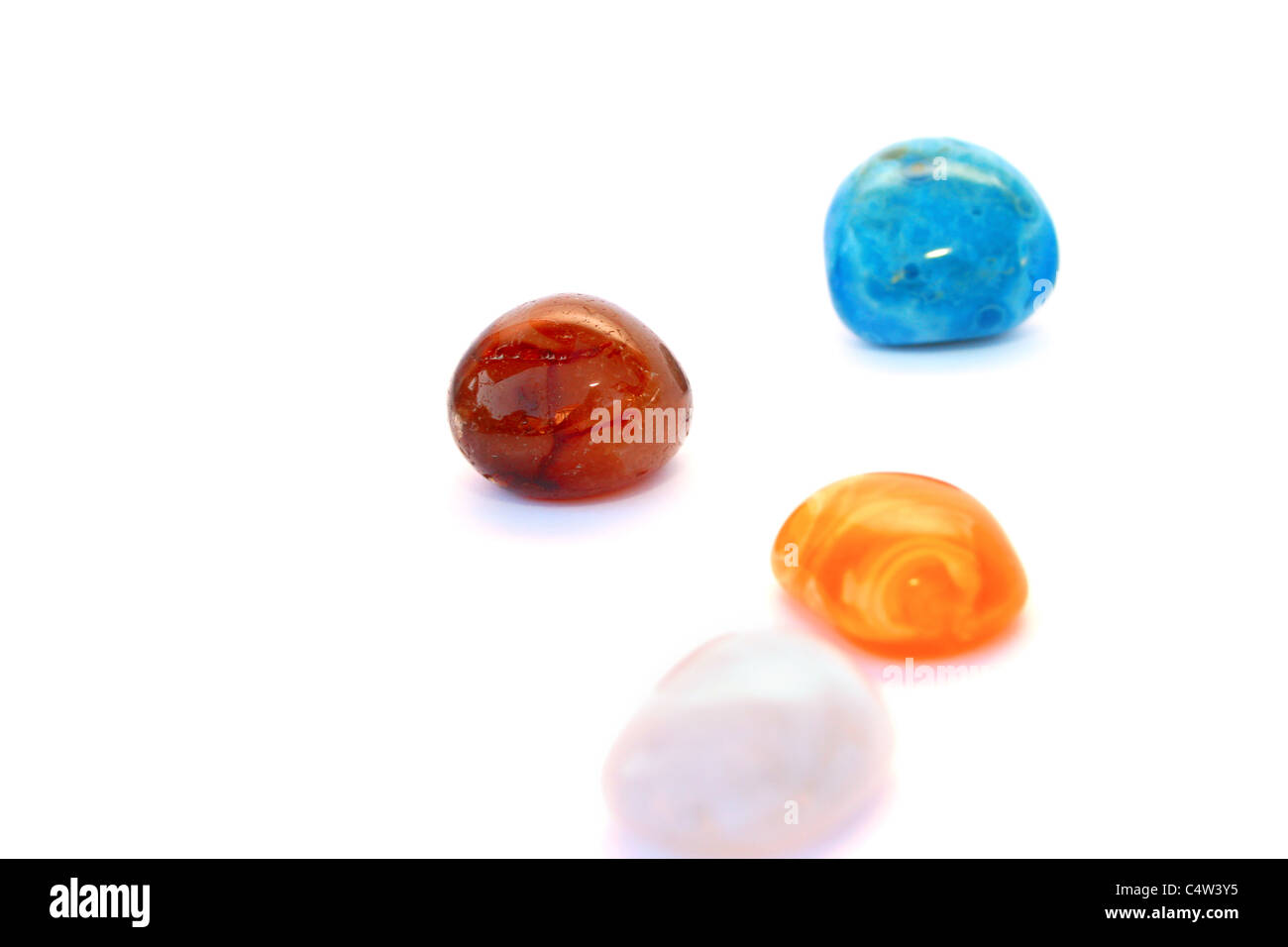Colorful stones isolated on white background Stock Photo - Alamy