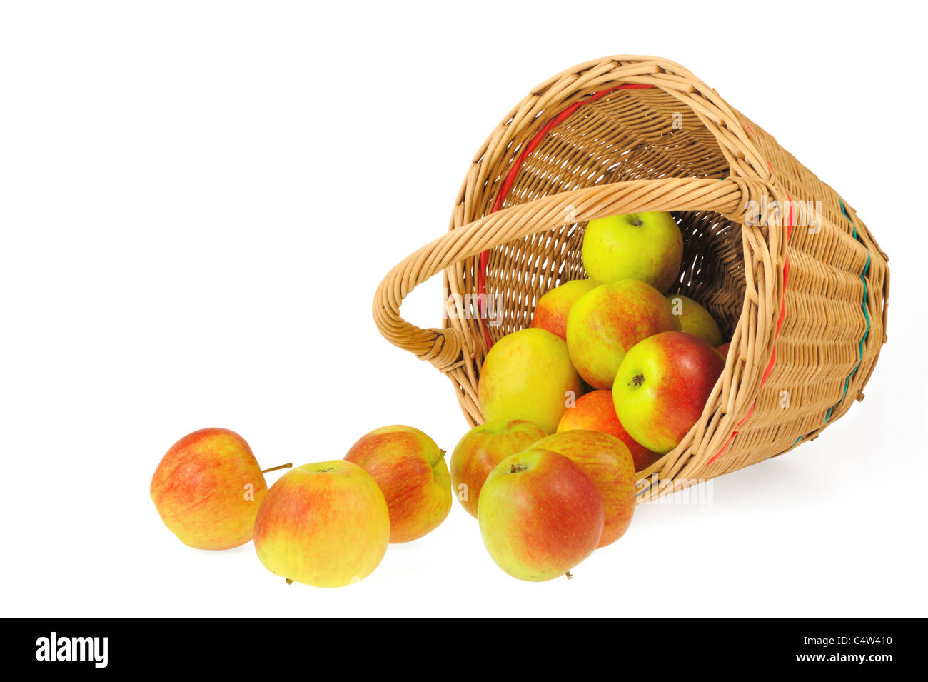 Fresh apples spilling out of basket - isolated. Clipping path included ...