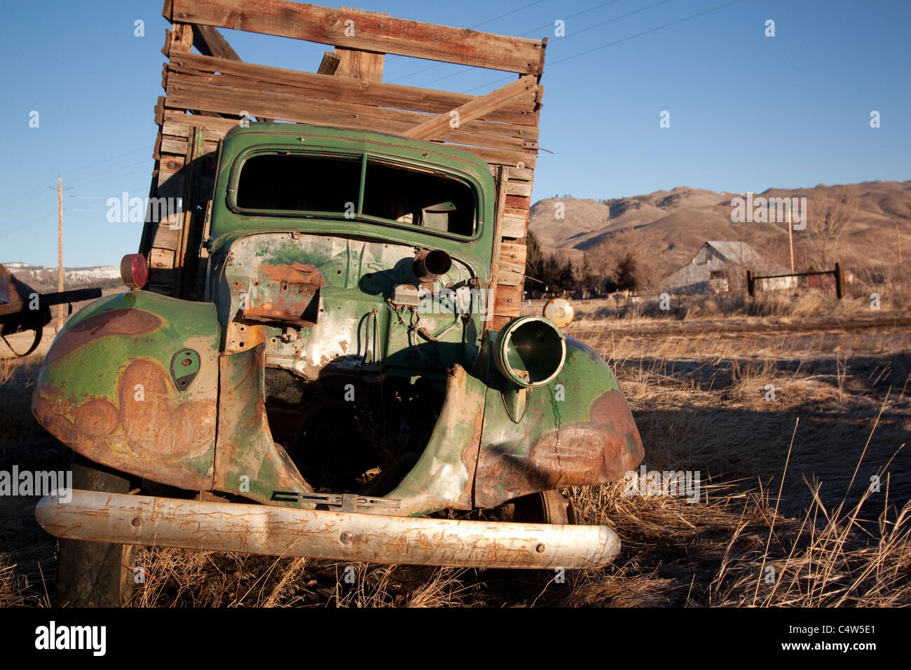 old rusty farm equipment in the middle of a field Stock Photo - Alamy