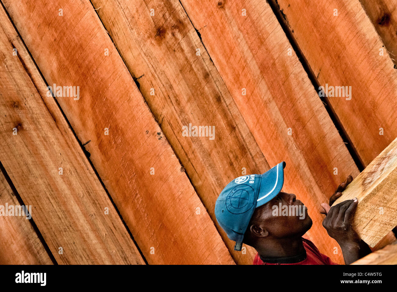 A Colombian worker stacks a timber from the rainforest at a sawmill ...