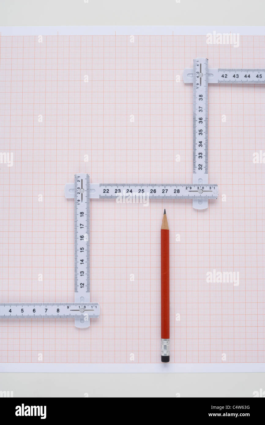 Folding Ruler, Pencil and Graph Paper Stock Photo - Alamy