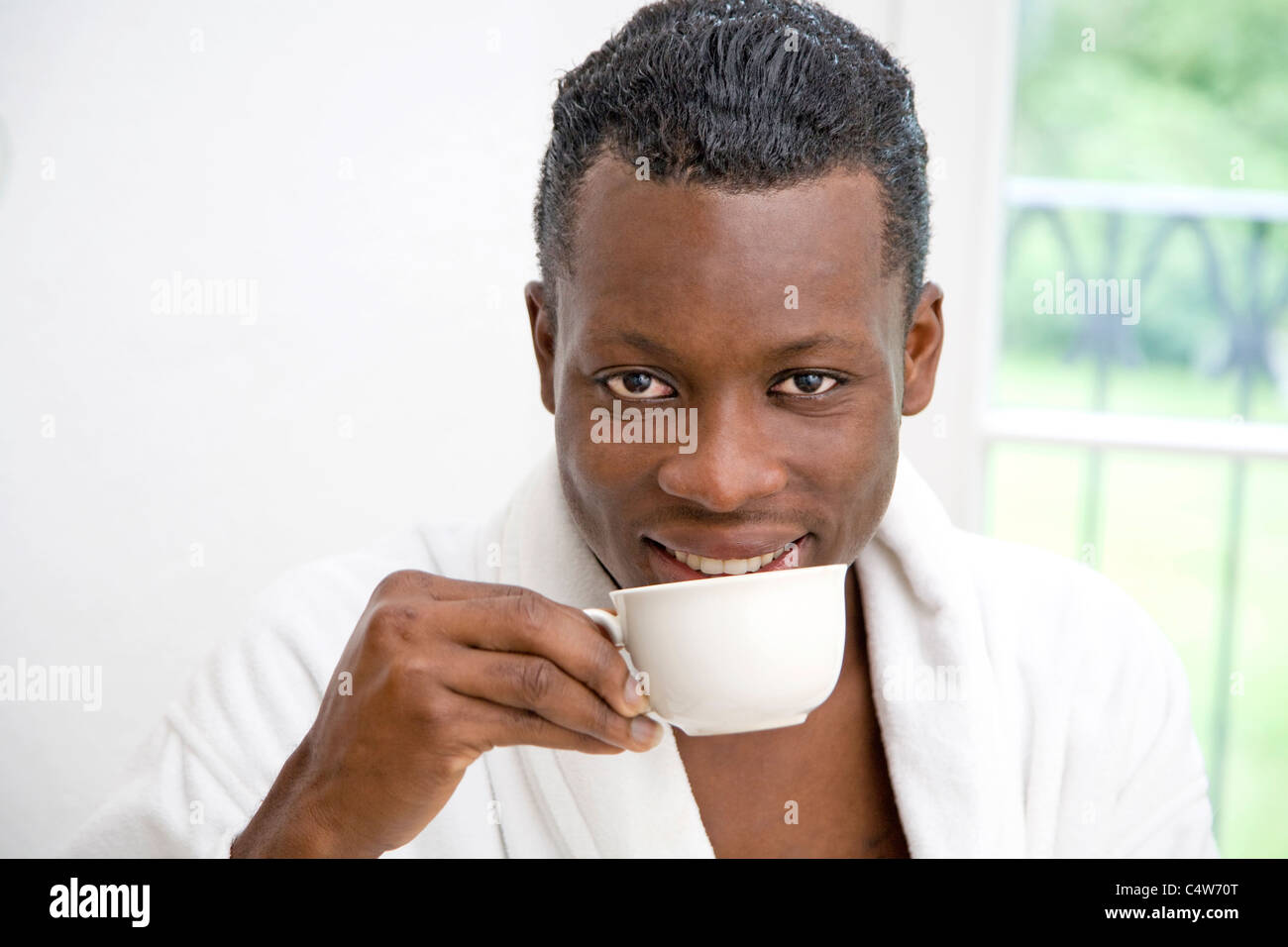Young African Man Drinking Stock Photo - Alamy