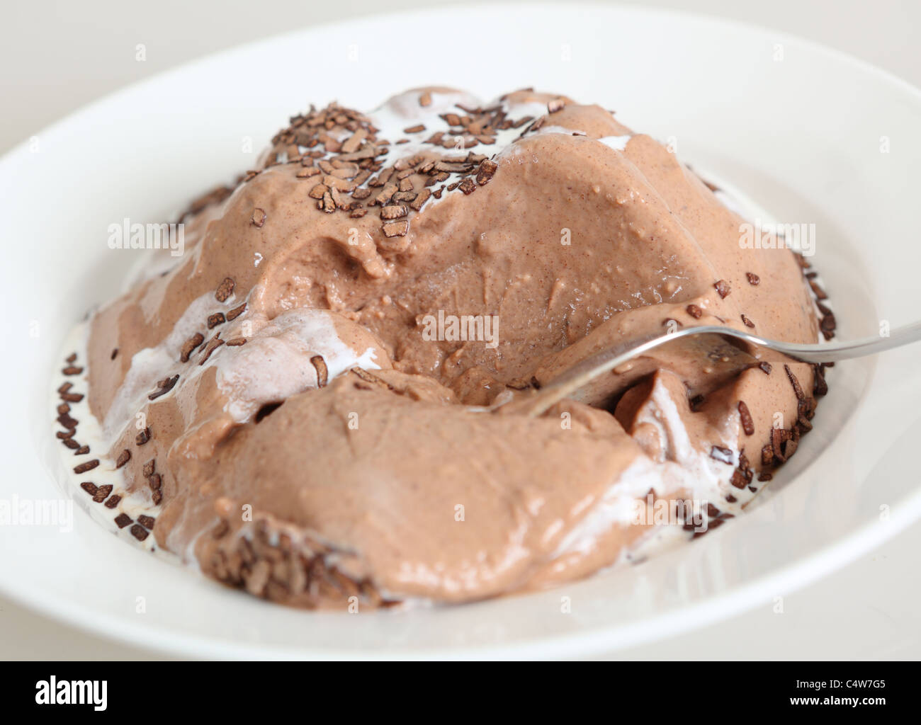 A chocolate blancmange-style pudding topped with cream and chocolate ...