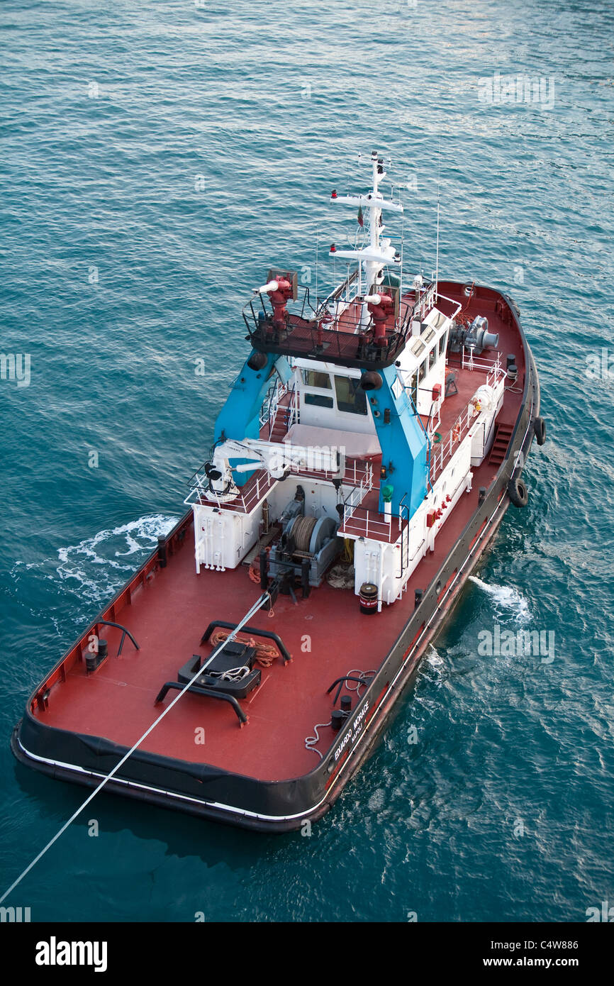 Tugboat pulling ship away from Quayside Civitavecchia Italy Stock Photo ...
