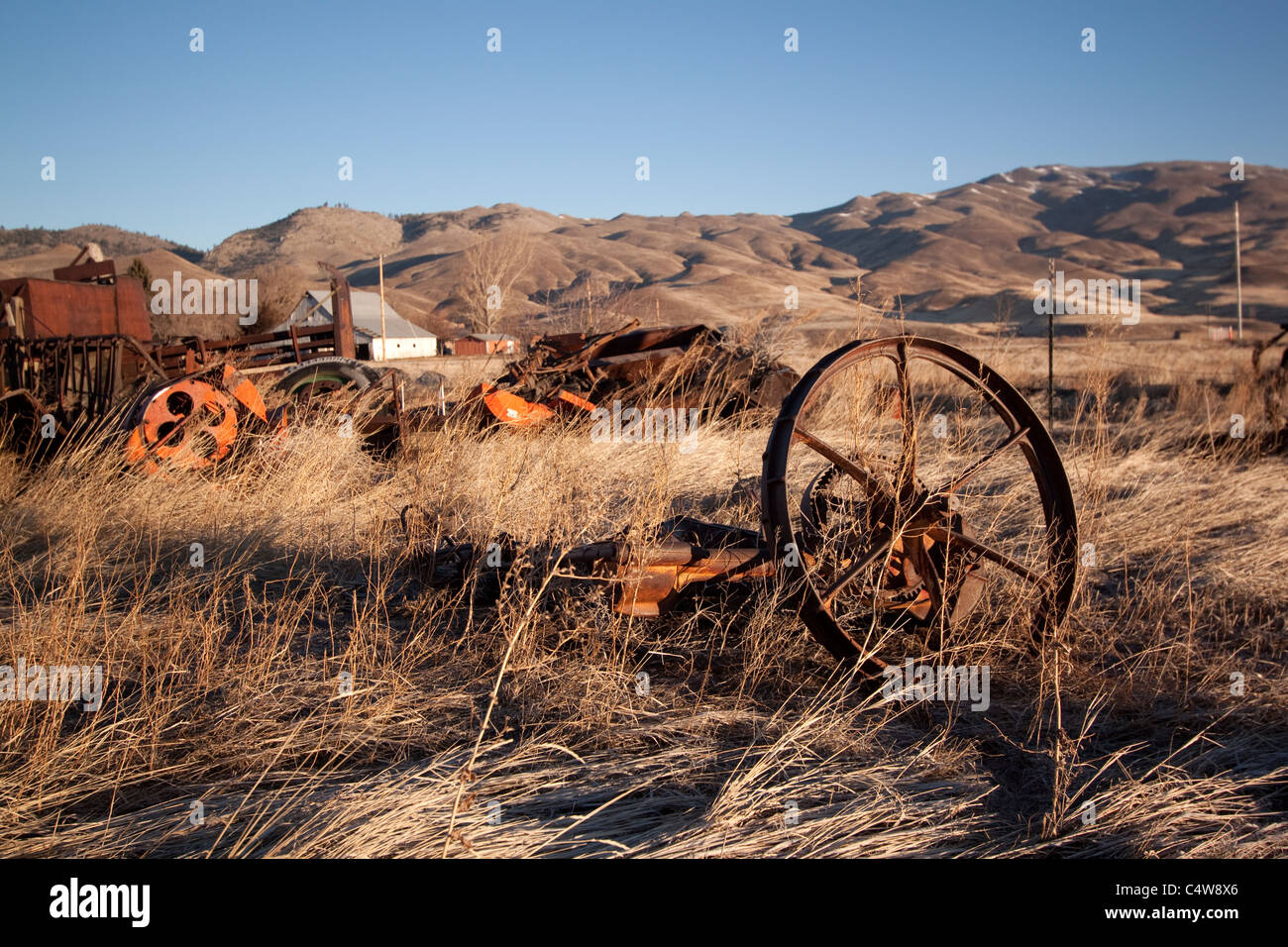 Old rustic farm equipment -- metal mechanical industrial worn wheel ...