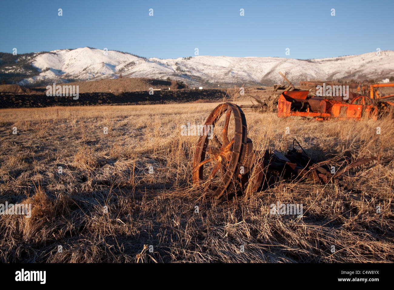 Old rustic farm equipment -- metal mechanical industrial worn wheel ...
