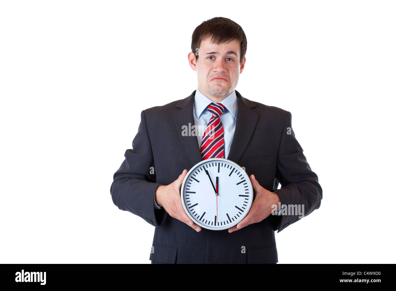 Stressed businessman holds clock in front and looks depressed.Isolated ...
