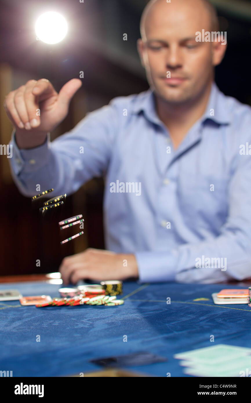 handsome confident man playing poker throwing chips Stock Photo - Alamy