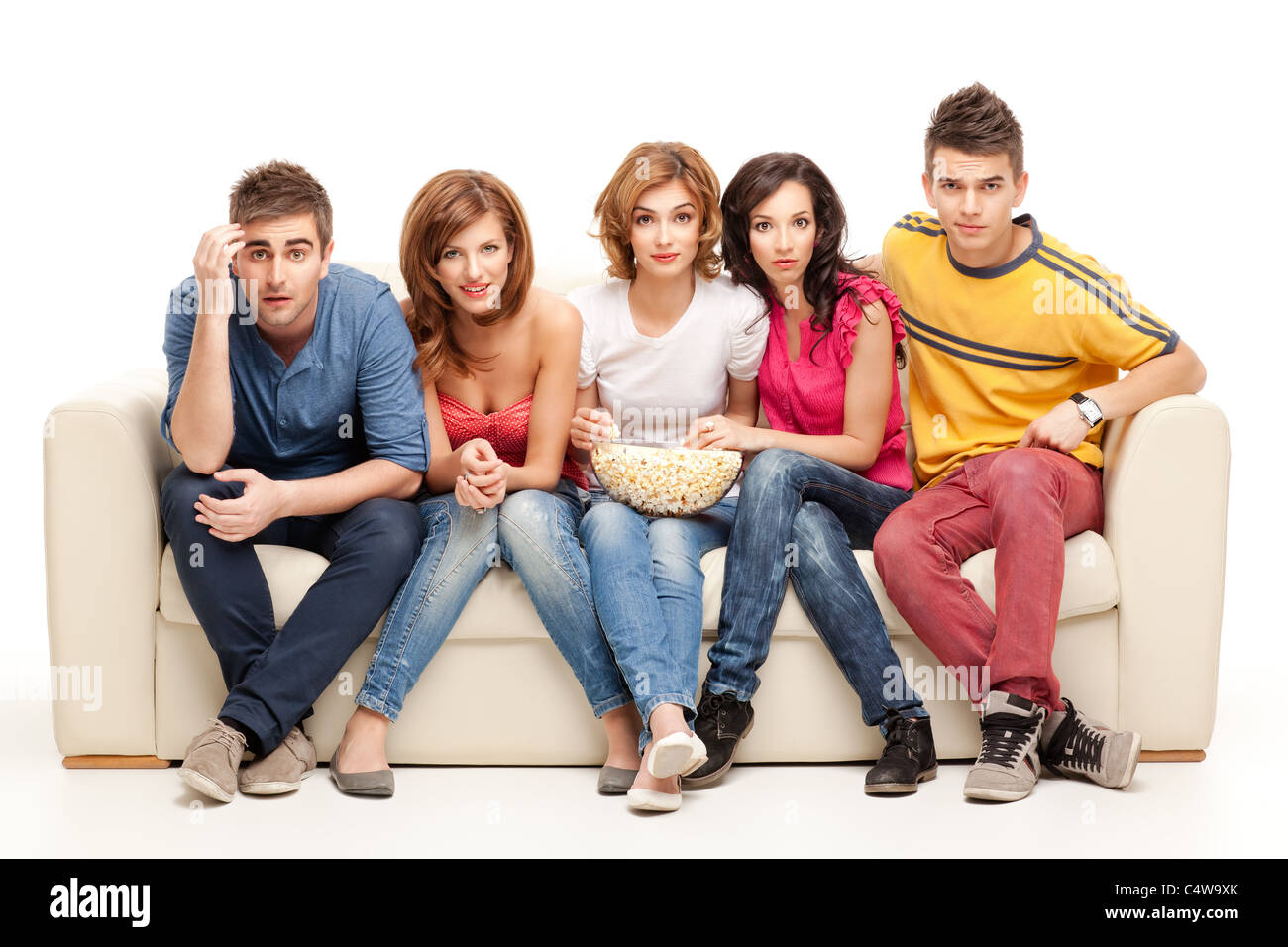 amazed friends sitting on couch watching movie with popcorn Stock Photo ...