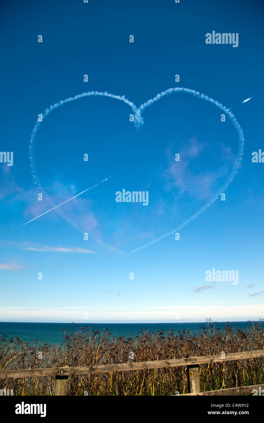 Heart shape with arrow made from jet smoke trails in the sky at air ...