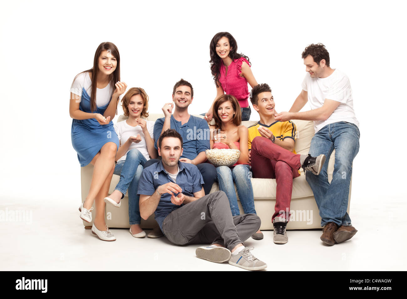 friends sitting on couch laughing at comedy movie Stock Photo - Alamy