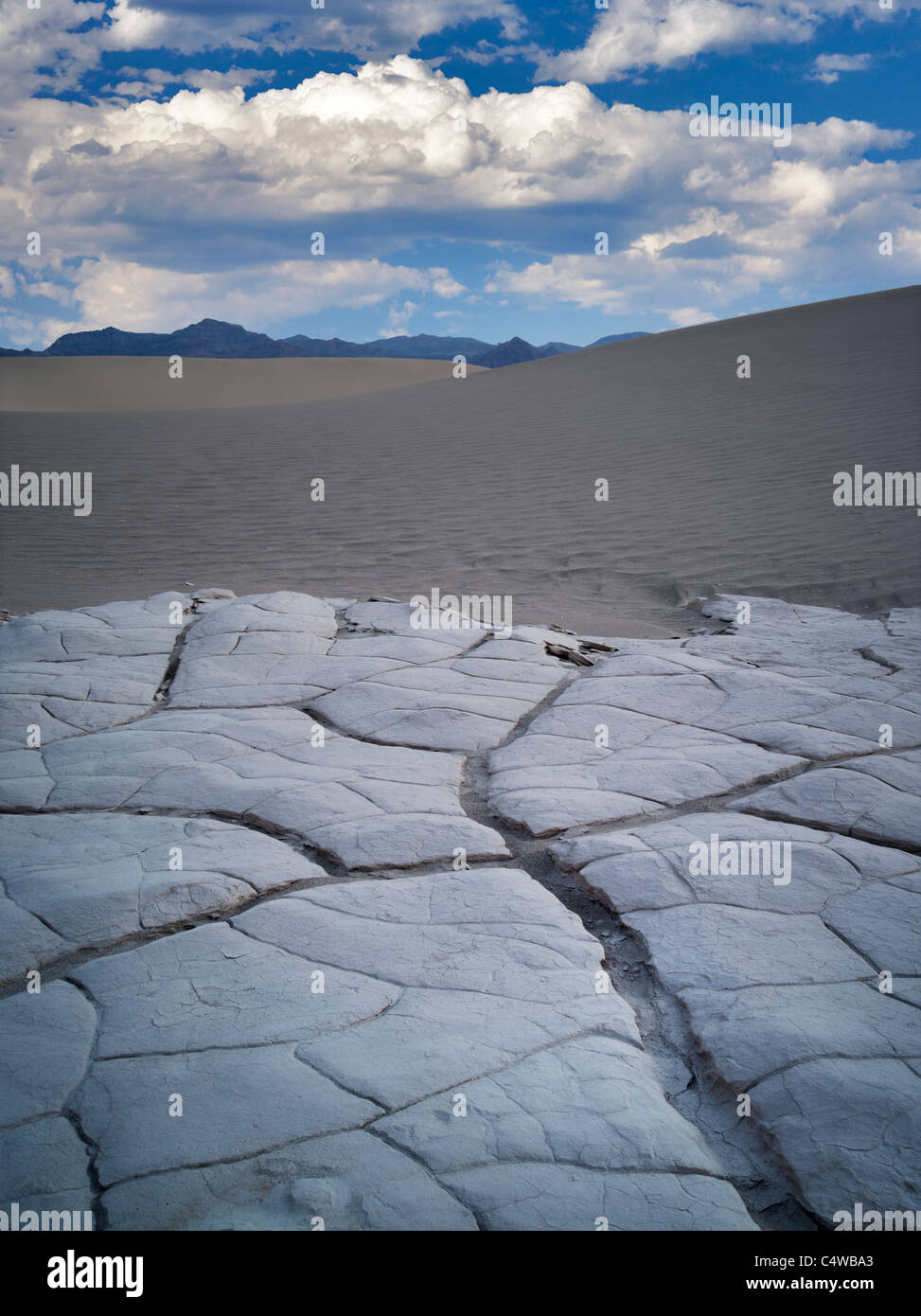 Mud patterns and dunes with sunrise. Death Valley National Park ...