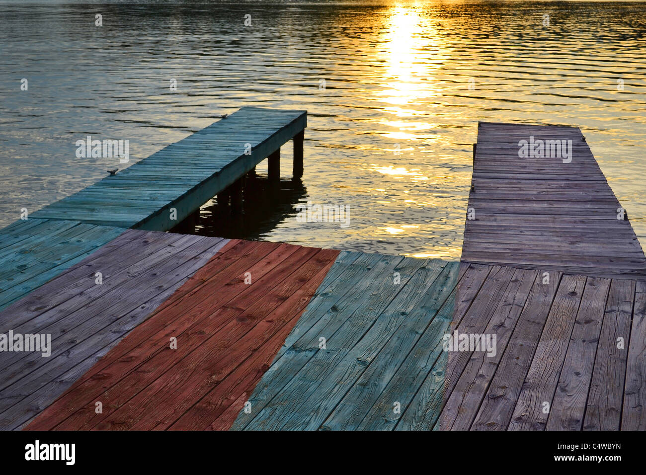 An old wooden boat dock on a lake at sunset Stock Photo - Alamy