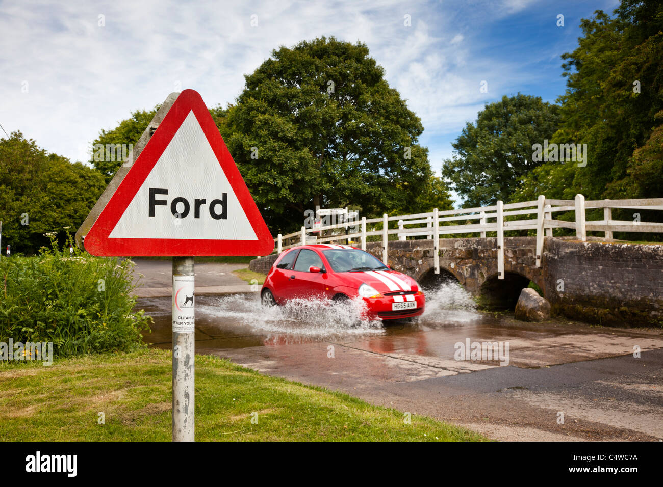 Vehicle car fording a river at Tarrant Monkton, Dorset, England, UK ...