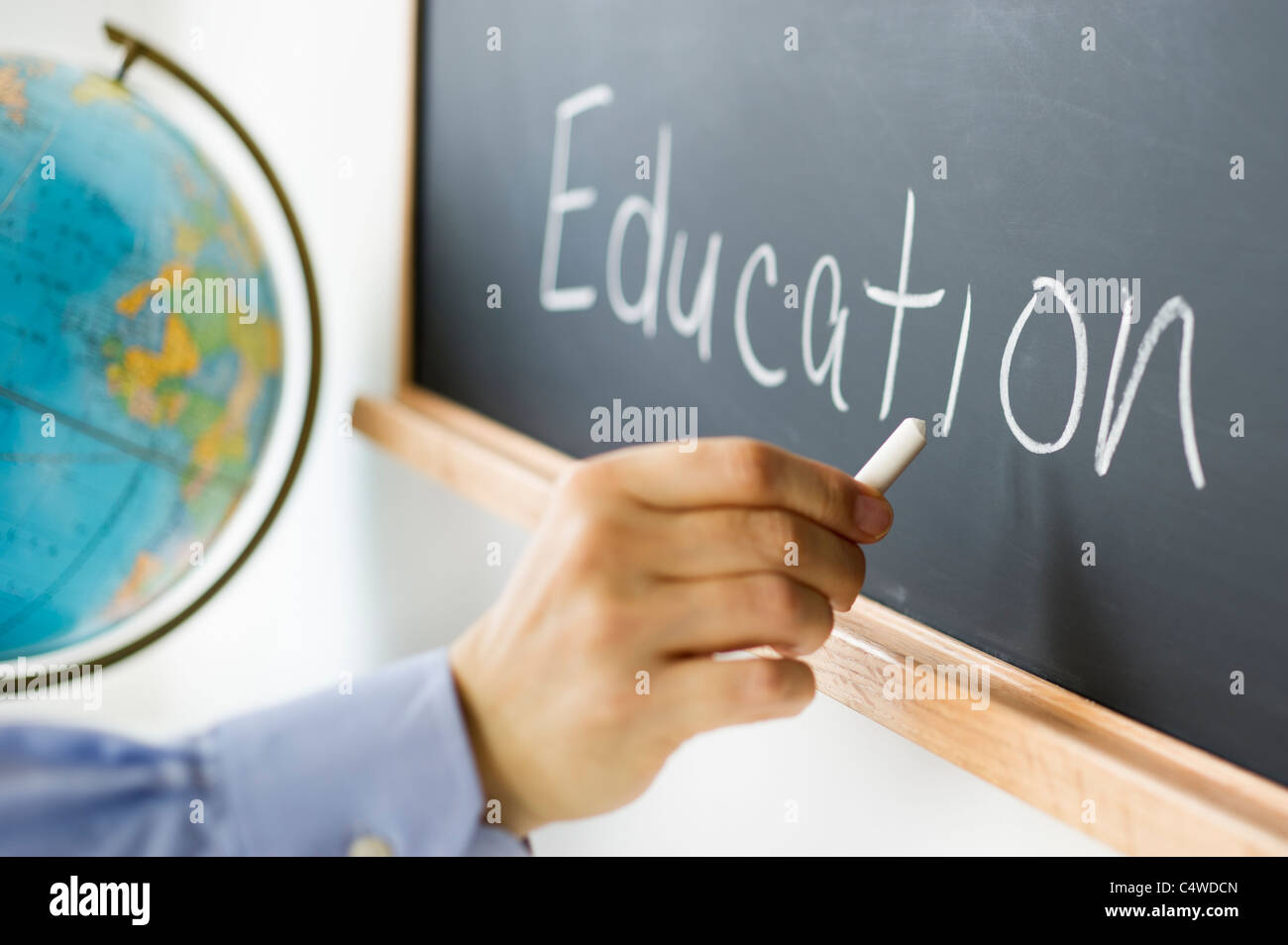 Man writing on blackboard hi-res stock photography and images - Alamy