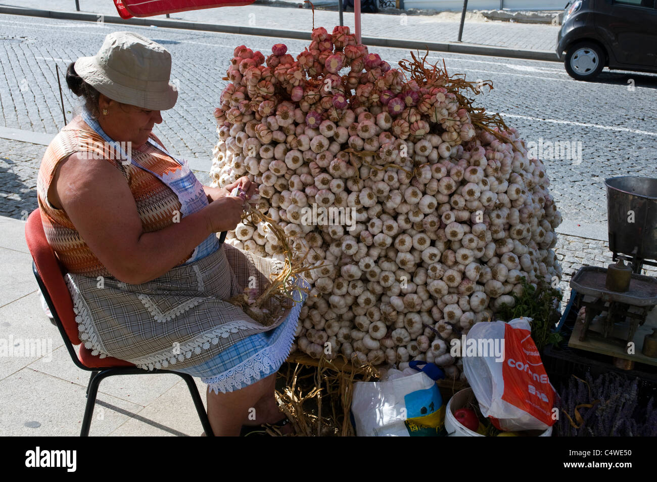an old lady preparing garlic for sale in Porto, Portugal Stock Photo ...