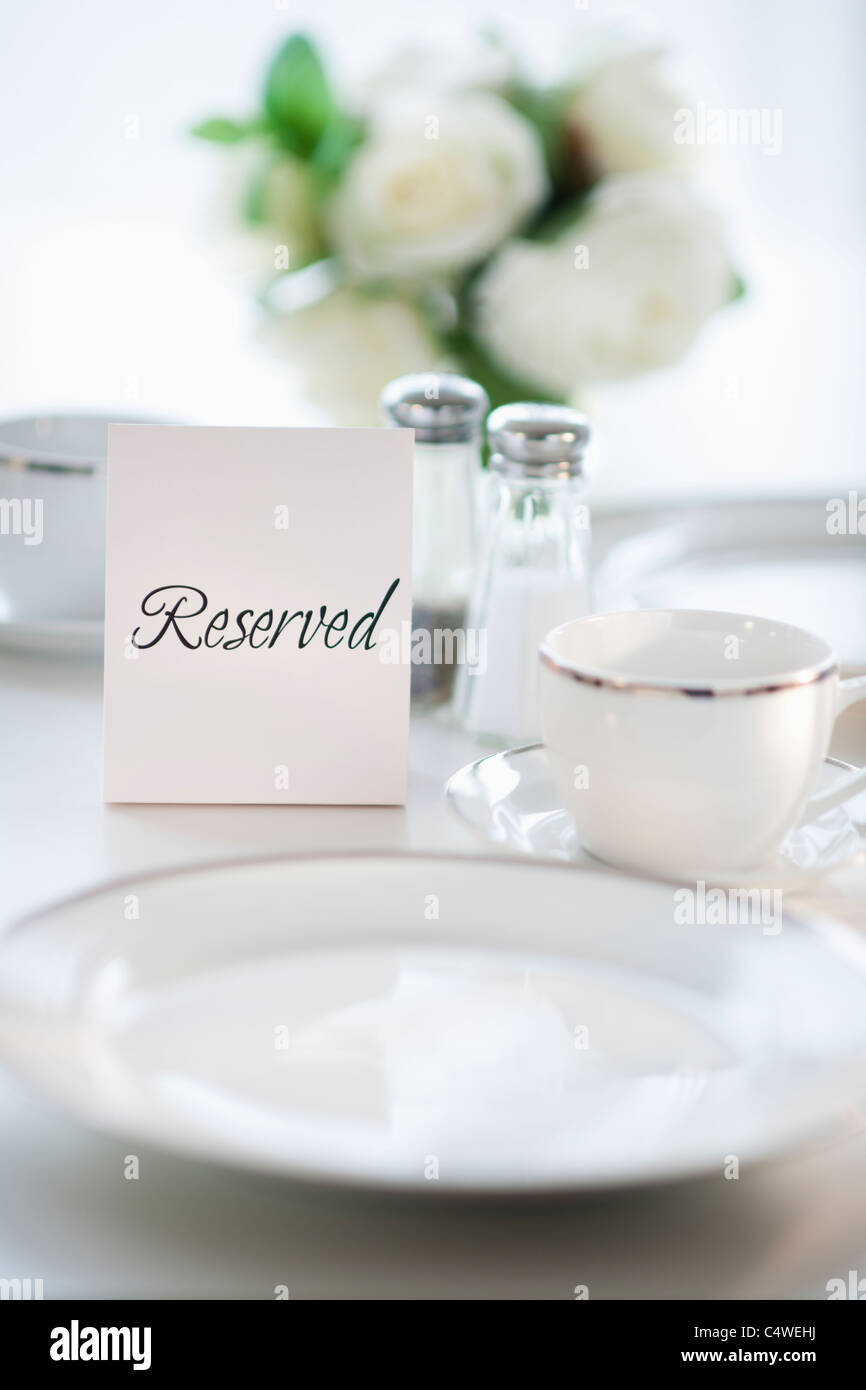 Close up of place setting with reserved sign Stock Photo - Alamy