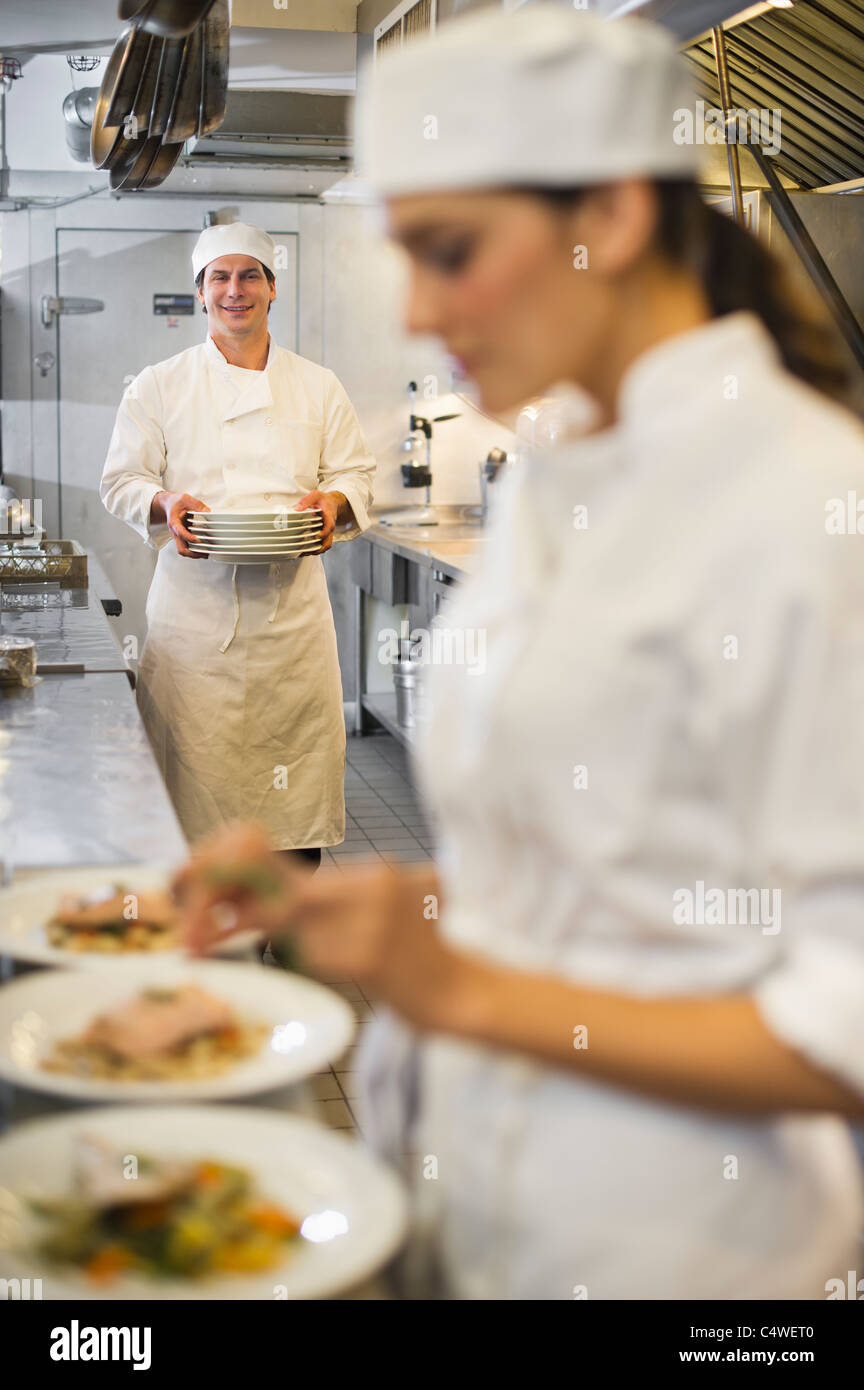 USA, New York, New York City, Chef and cook preparing food in ...
