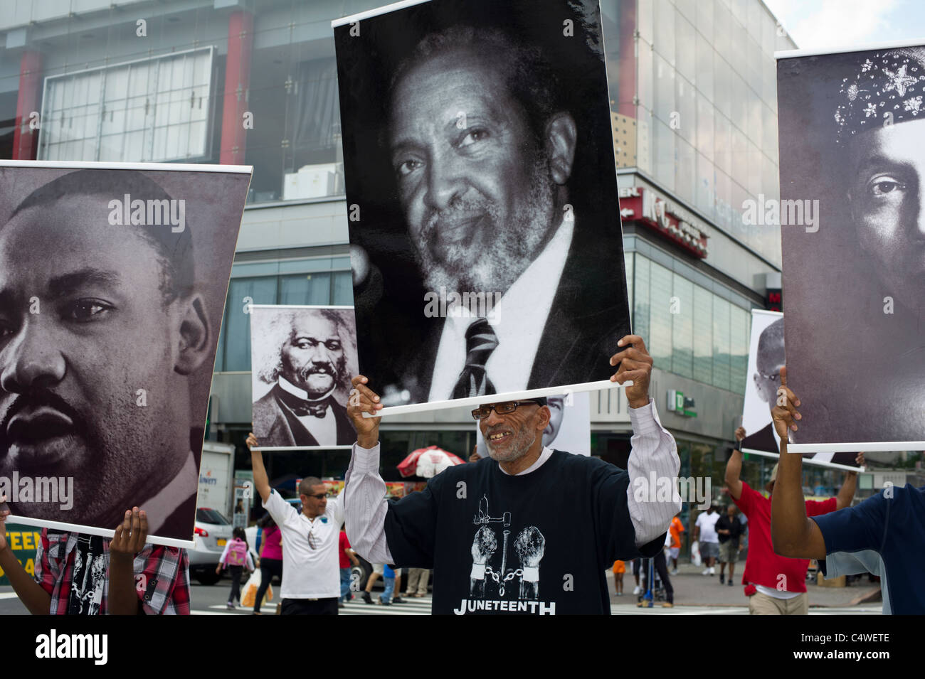 Participants march in the Juneteenth celebration parade in Harlem in ...
