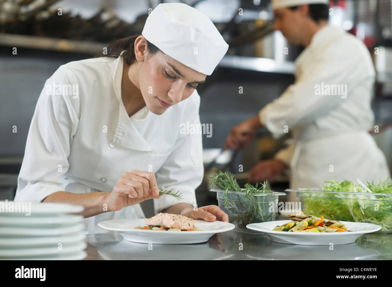 USA, New York, New York City, Chef and cook preparing food in ...