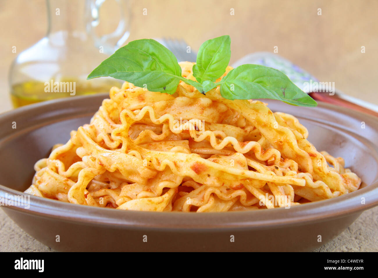 Italian pasta tripoline with tomato sauce and basil Stock Photo - Alamy