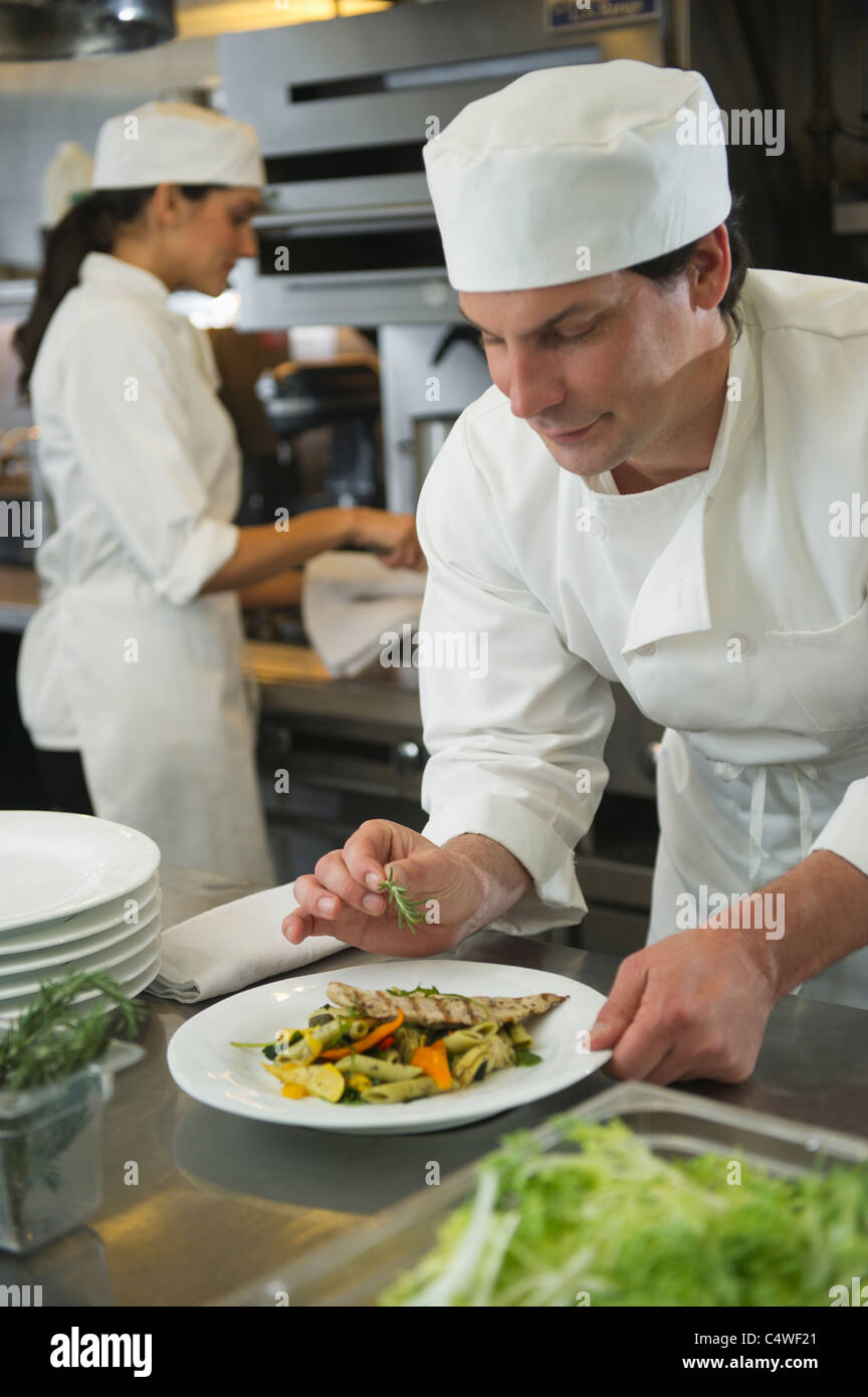 USA, New York, New York City, Chef and cook preparing food in ...