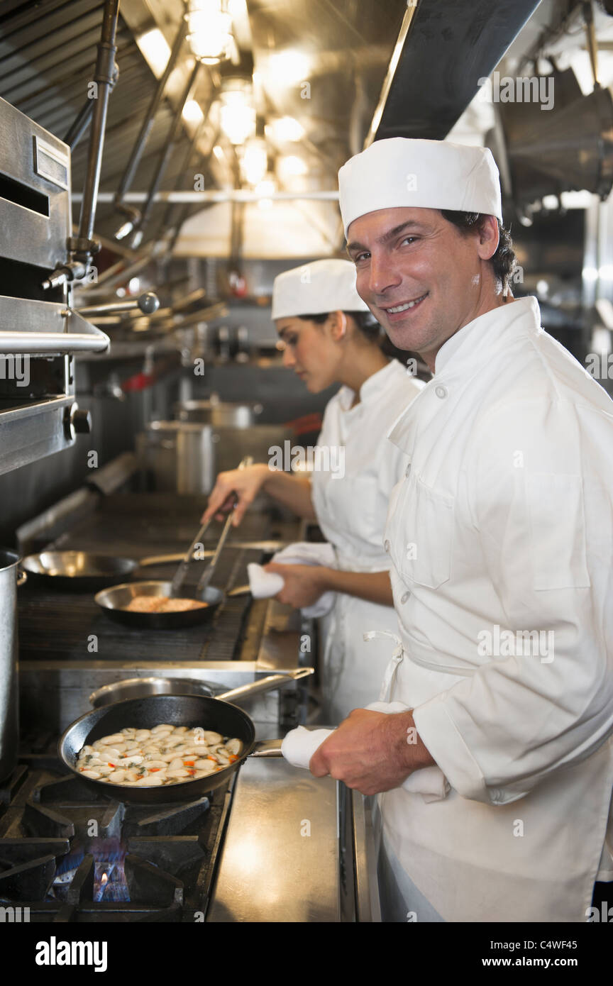 USA, New York, New York City, Chef and cook preparing food in ...