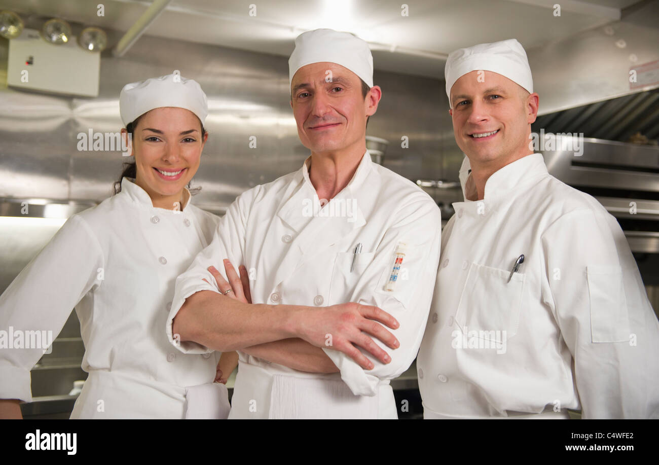 USA, New York State, New York City, Three chefs posing in kitchen Stock ...