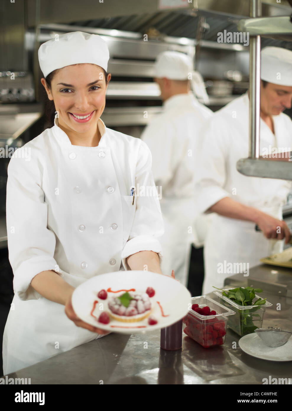 USA,New York State,New York City,Chefs preparing food in kitchen,women ...