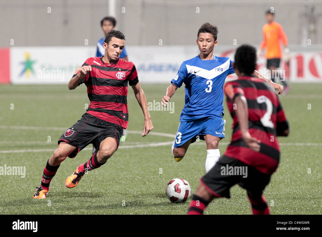 Mahathir Azeman of Singapore U15(blue) attempts to get past Arlindo ...