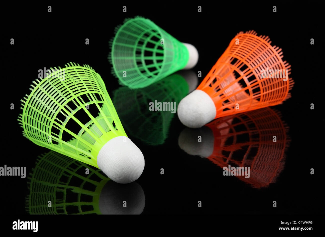 Three colored shuttle badminton on a black background Stock Photo - Alamy