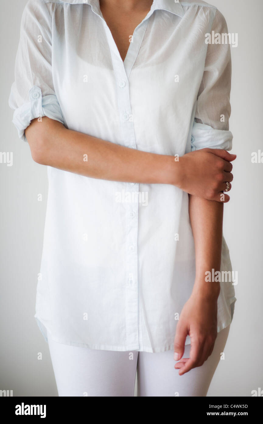 Mid section of woman dressed in white Stock Photo - Alamy