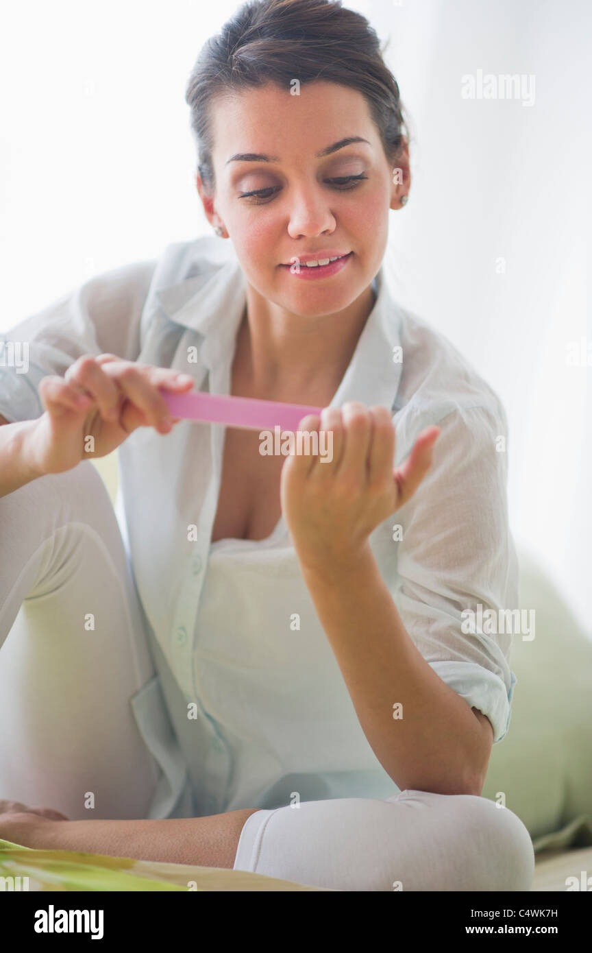Attractive young woman filing nails hi-res stock photography and images ...