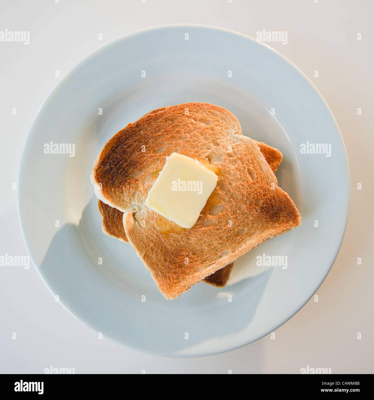 Close up of toasts with butter on plate Stock Photo - Alamy