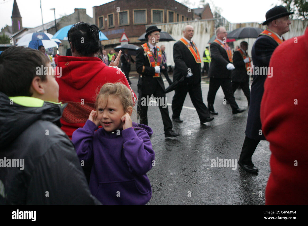 NORTHERN IRELAND, BELFAST : A young girl covers her ears while at a Pro ...