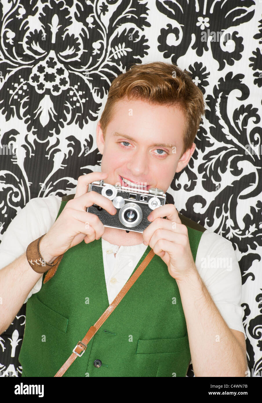 Studio portrait of young man using still camera Stock Photo - Alamy