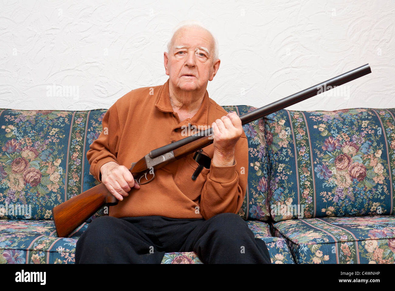 A retired elderly Senior Man holding a shotgun Stock Photo - Alamy